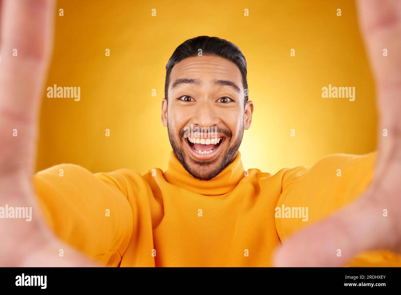 Excited, portrait and selfie of man in studio isolated on a yellow ...