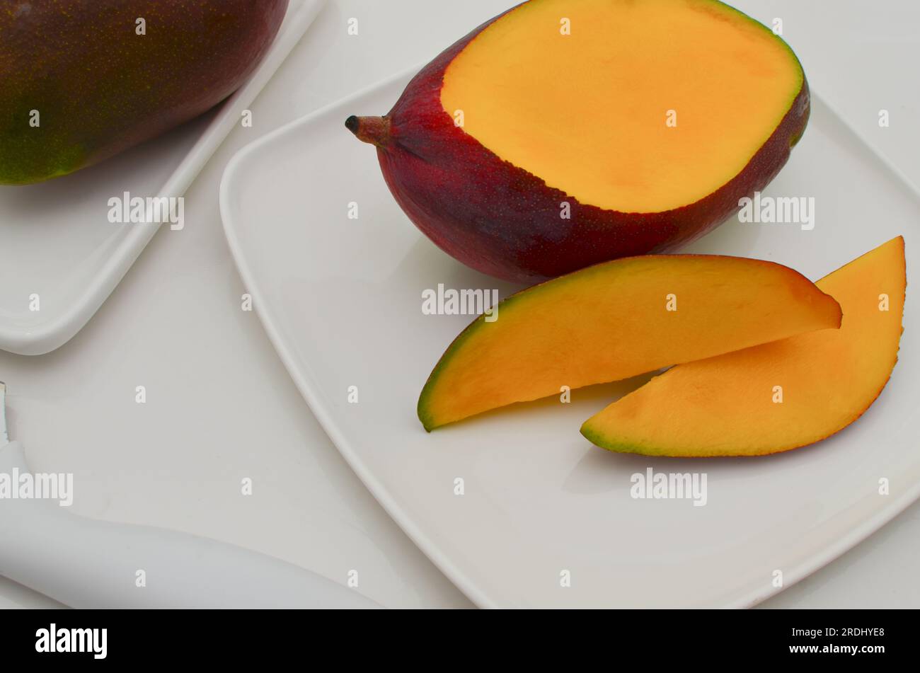 Detail of a perfectly sliced ripe yellow mango, ready to be tasted and ...