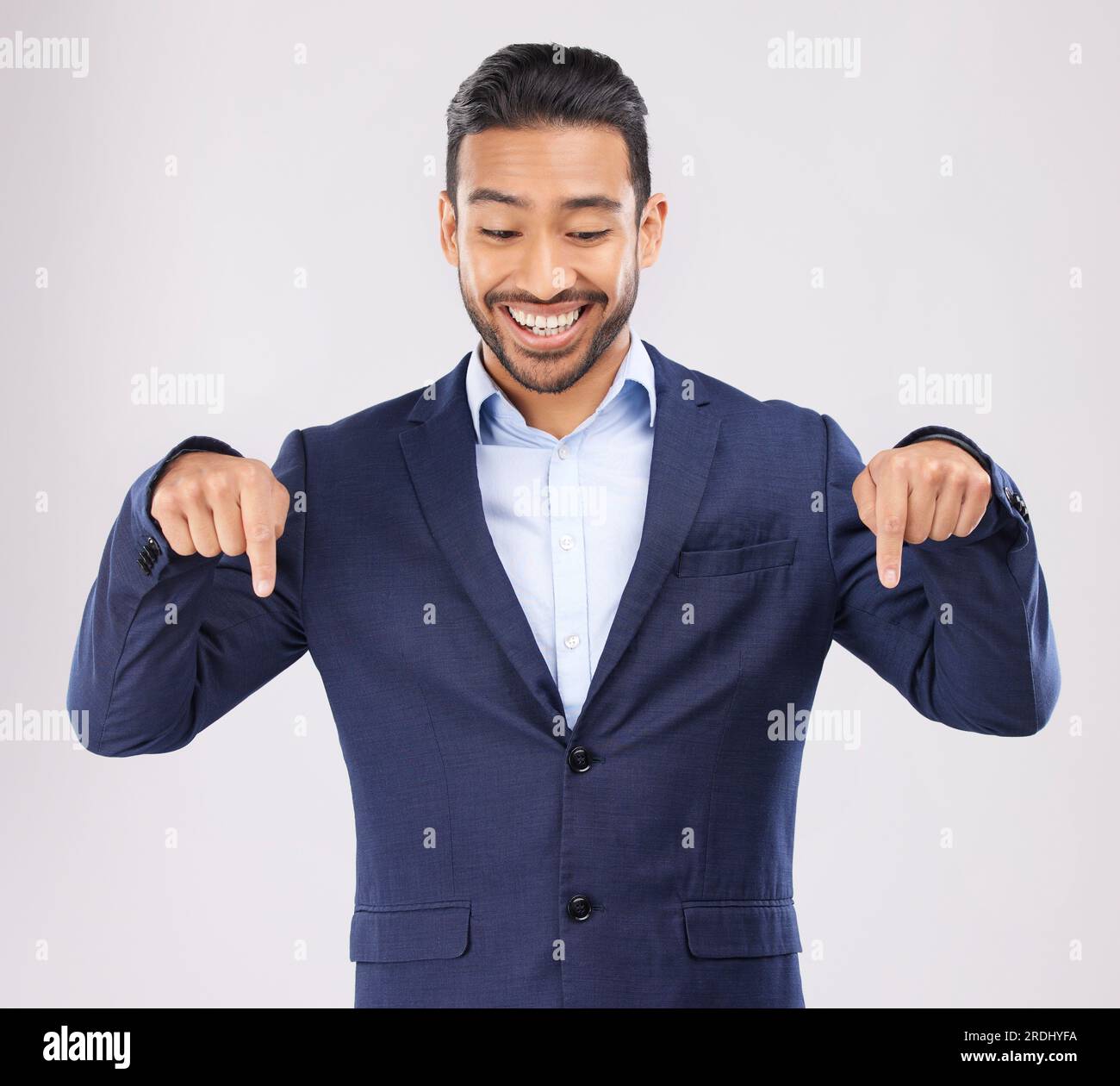 Down, hand pointing and asian man in studio with sale, announcement or ...