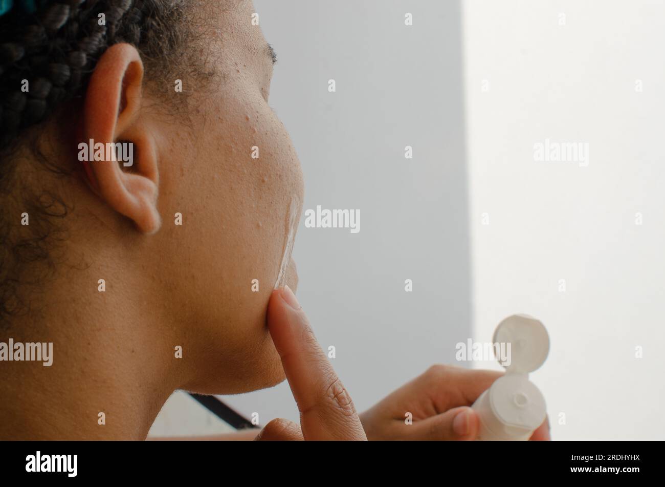 Face like canvas, skillful hands applying face cream, creating an ...