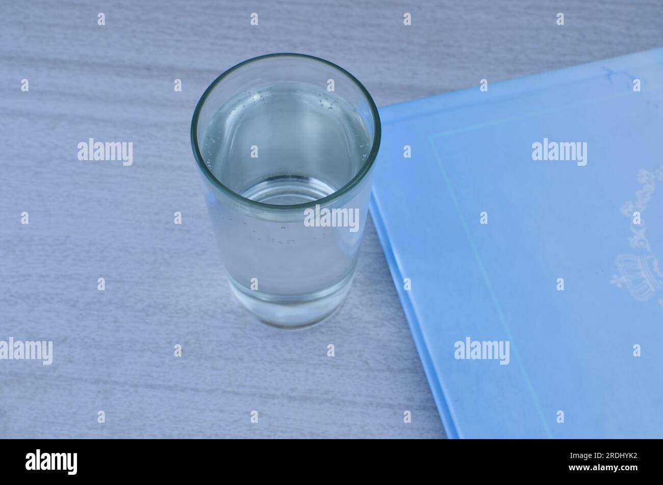 Glass with refreshing water in focus, symbolizing the importance of ...