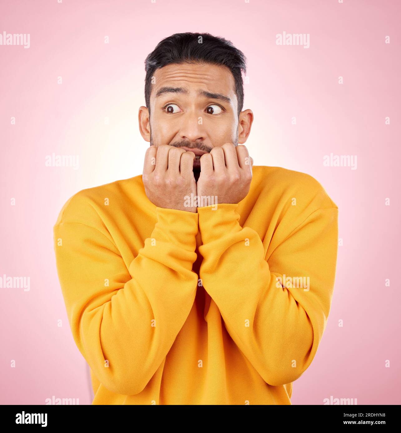 Anxiety, thinking and asian man biting nails in studio with terror ...