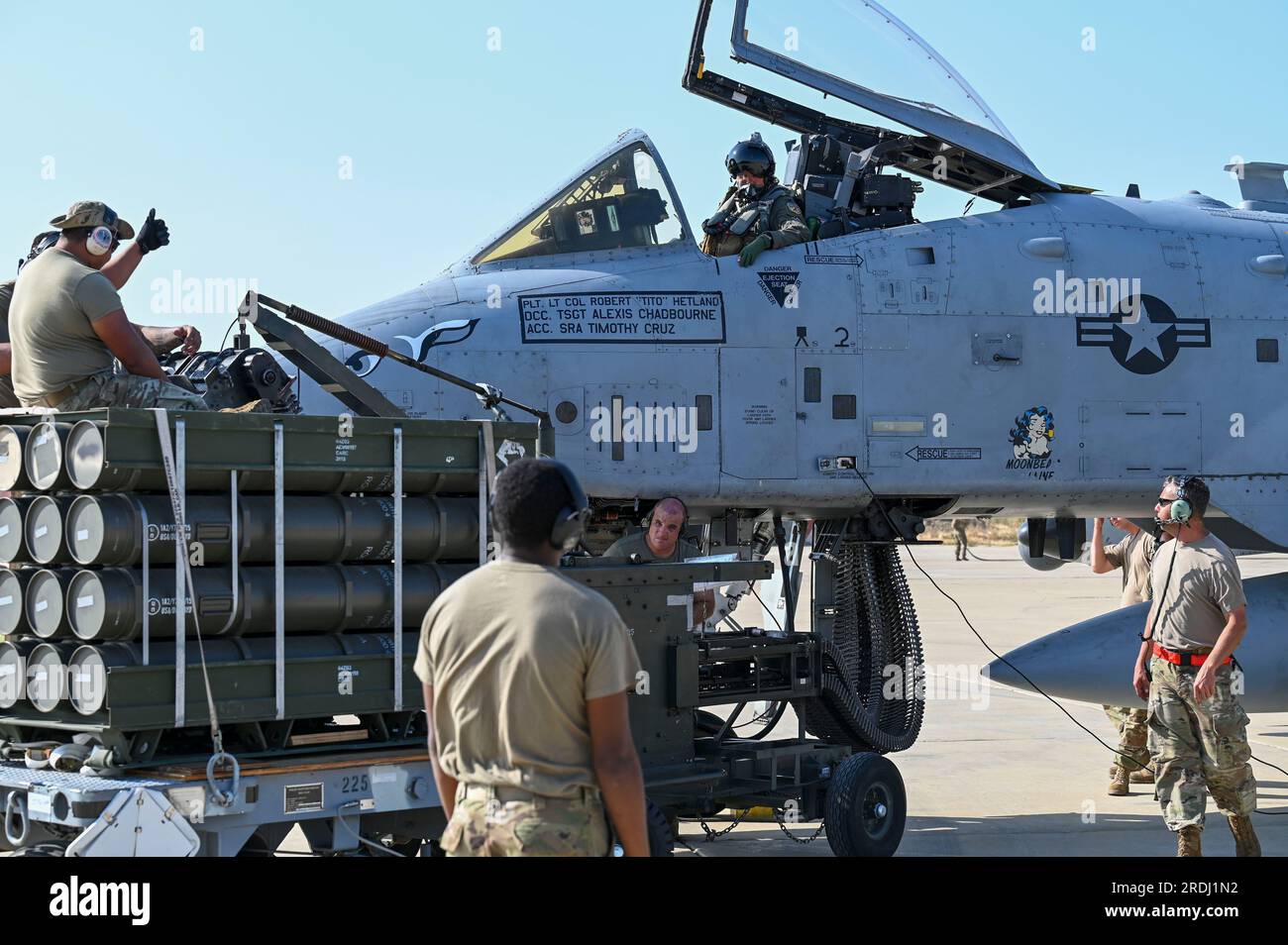An armament team reloads an A-10 attack aircraft with rockets and 30mm ...