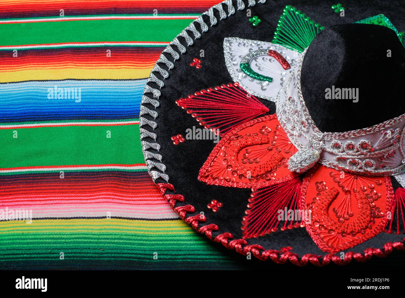 Mariachi hat with the colors of the Mexican flag on a colorful serape ...