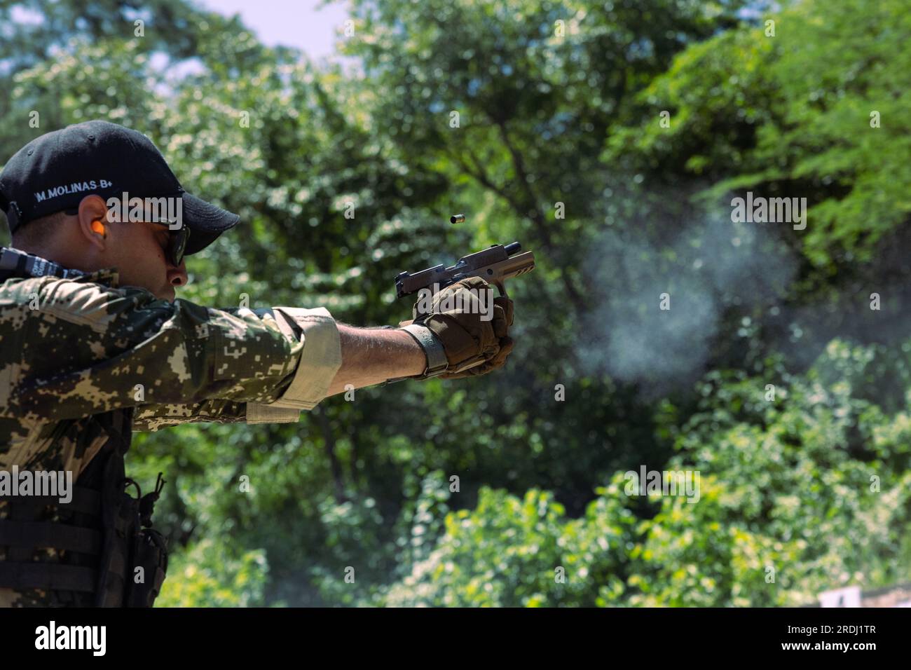 A Paraguayan Marine fires a U.S. Marine Corps M18 service pistol during tactical pistol training ...