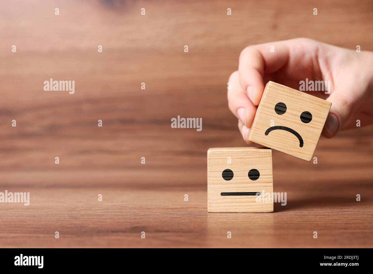 Complaint. Woman choosing cube with drawn sad face instead of another ...