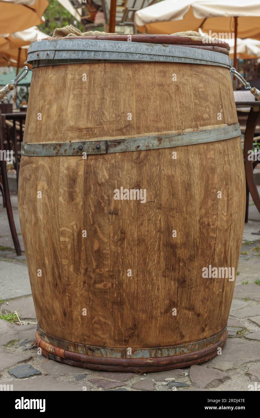 Traditional wooden barrel on city street outdoors Stock Photo - Alamy