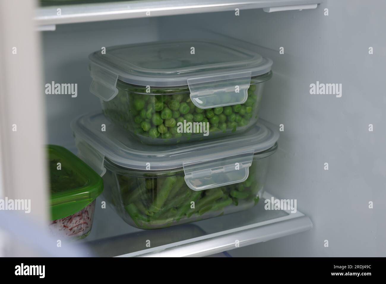Glass containers with different fresh products in fridge. Food storage ...