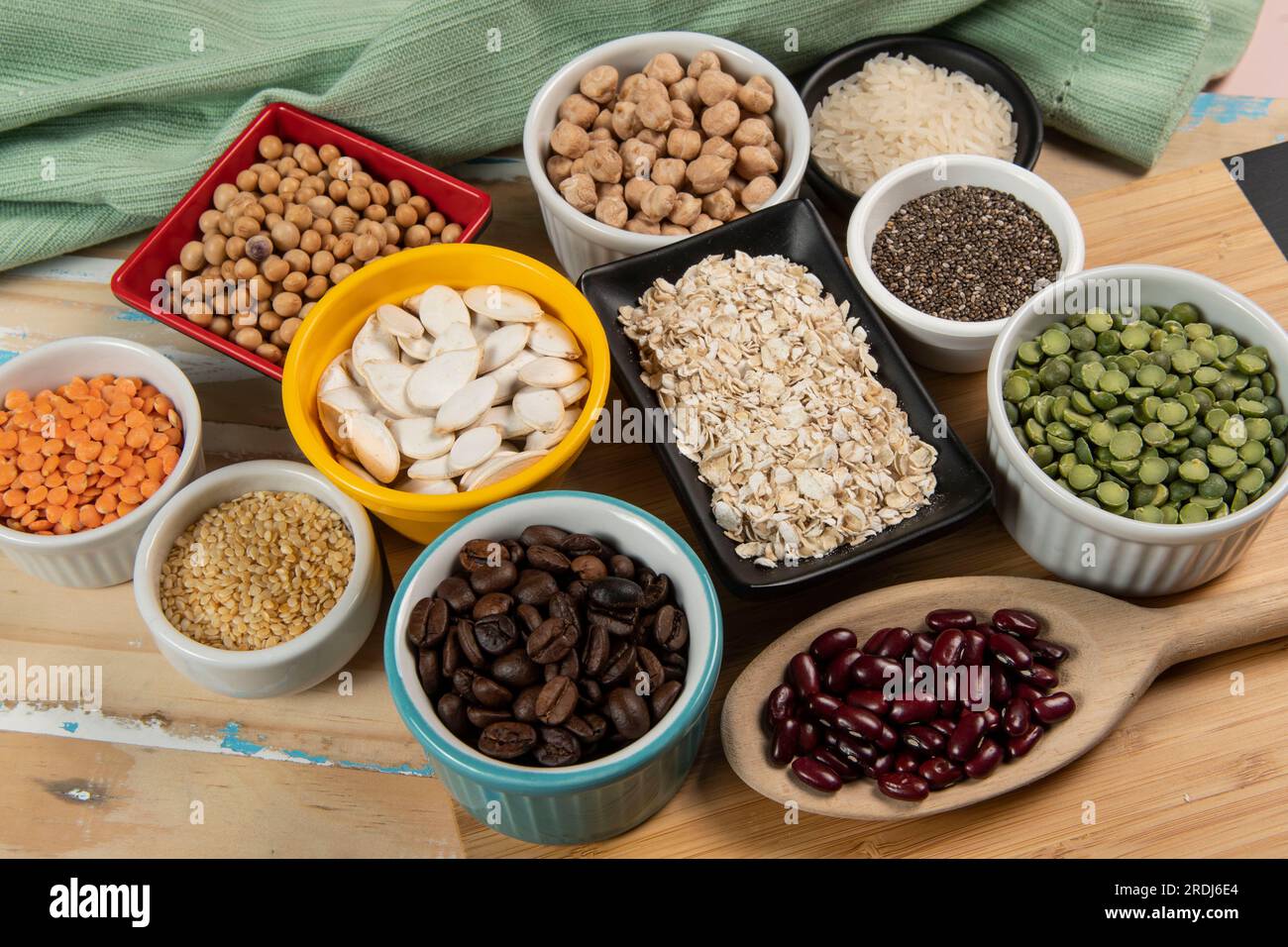Different types of legumes in bowls, green and yellow peas, chickpeas ...