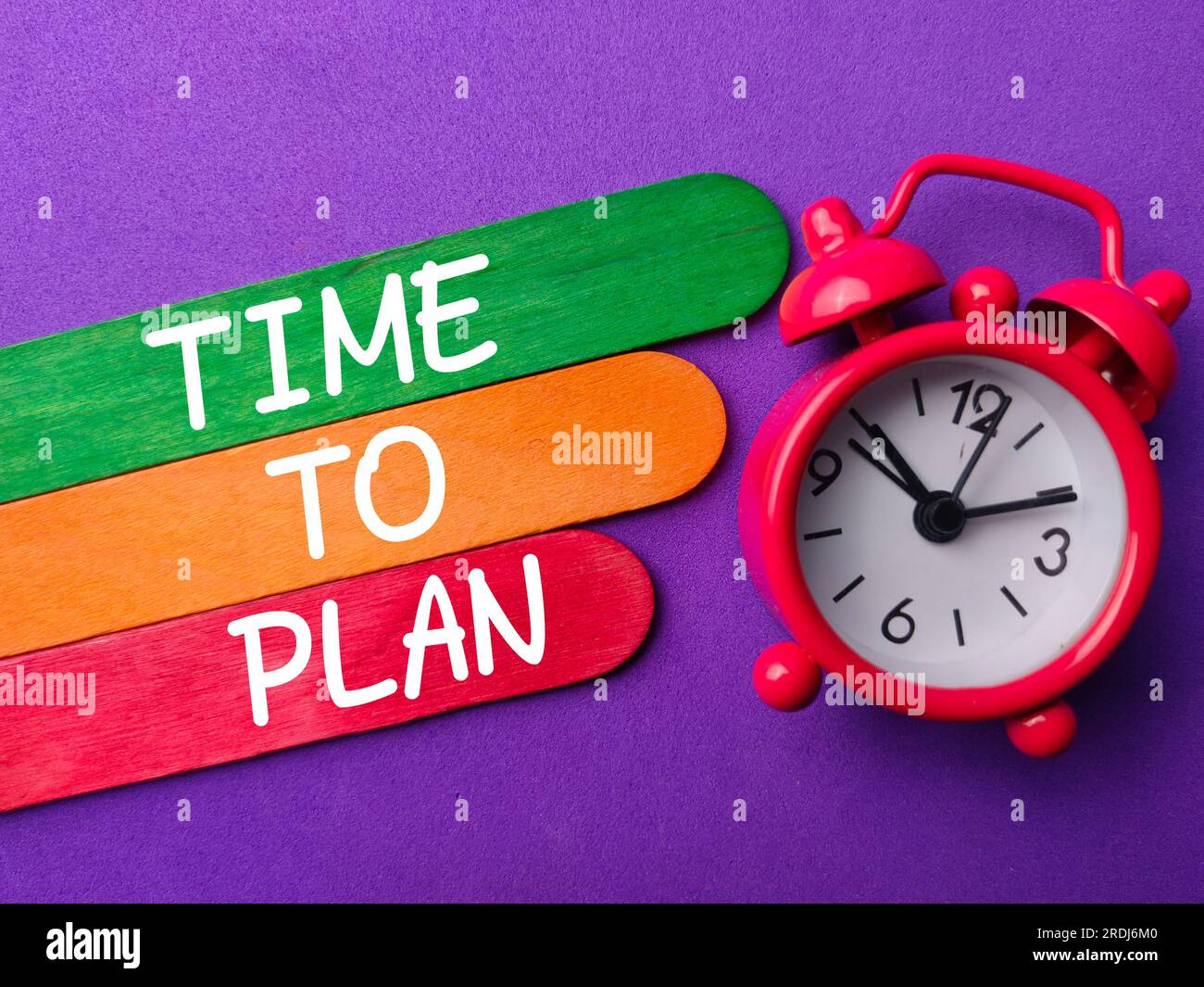 Red alarm clock with the word TIME TO PLAN on a purple background Stock ...
