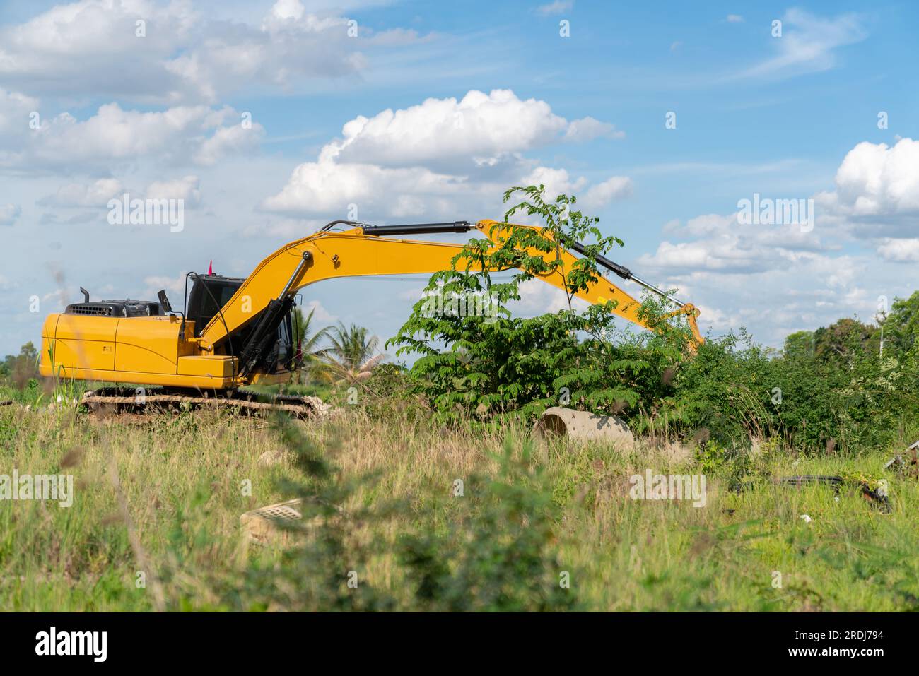 Digger machine digging and adjusting ground level in construction site ...