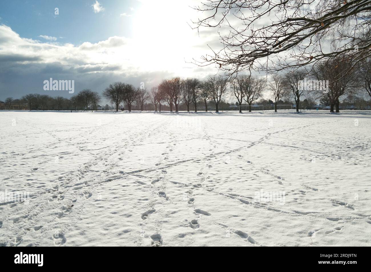 Footprint path drawn on the snow in a public park in England Stock ...