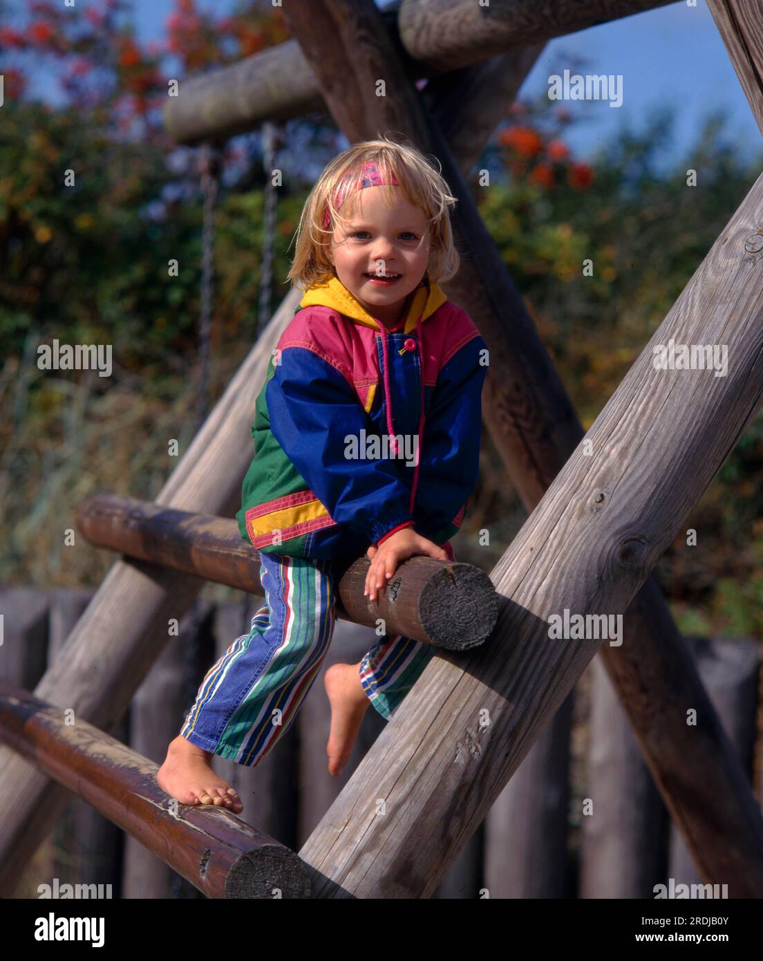 Little girl on climbing frame Stock Photo - Alamy