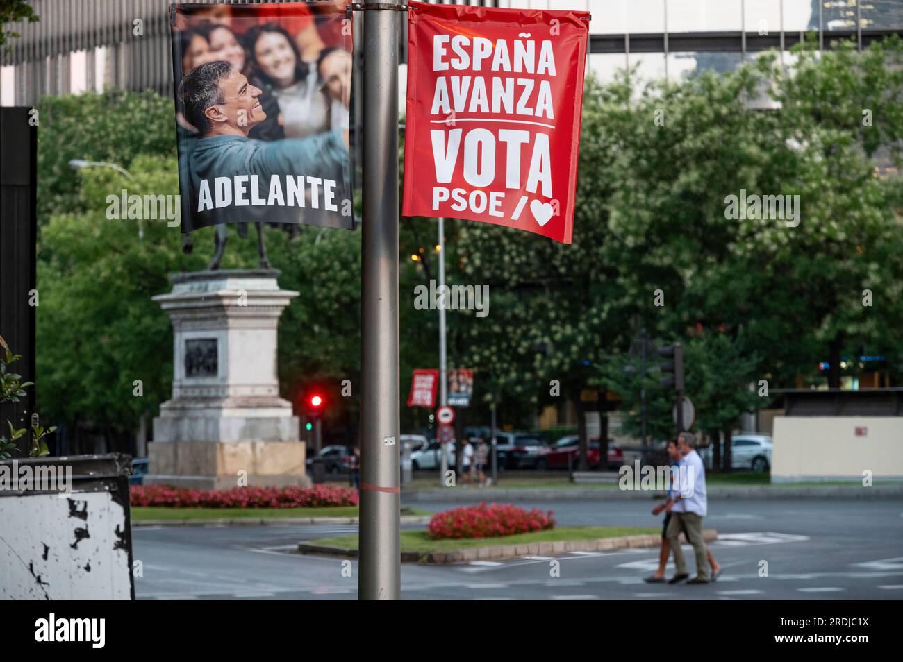 Madrid, Spain. 22nd July, 2023. Pedestrians cross the road as a banner ...