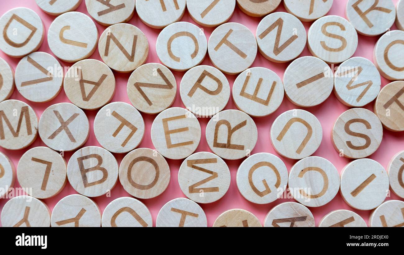 Circle wooden alphabet over a pink background Stock Photo - Alamy