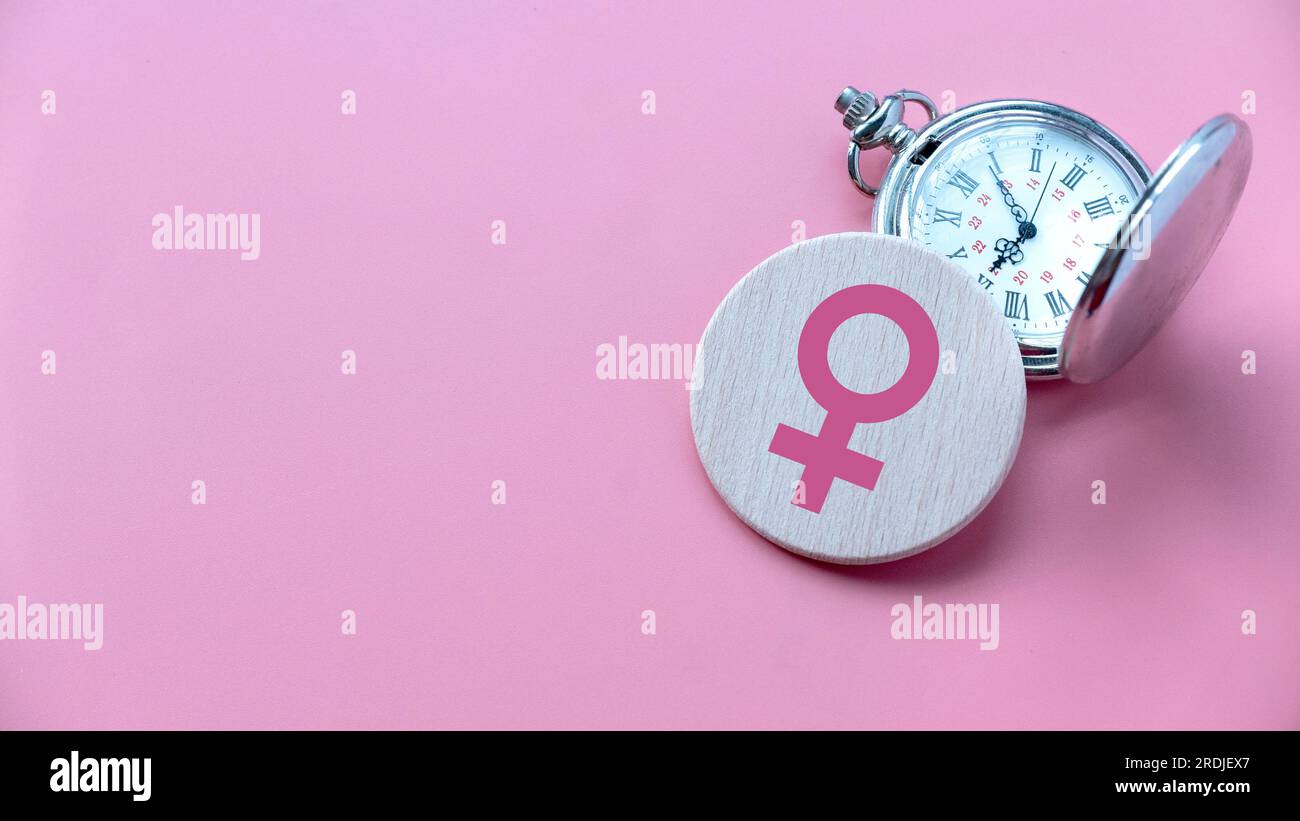 Menopause concept. Women symbol over a watch. Healthcare and medical ...