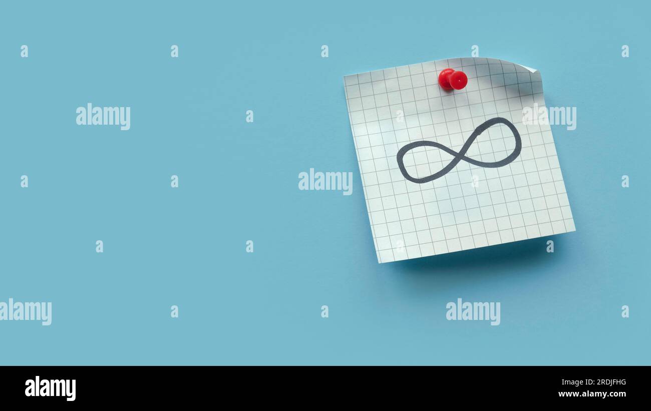 Infinity sign or symbol handwritten on a memo note over blue background ...
