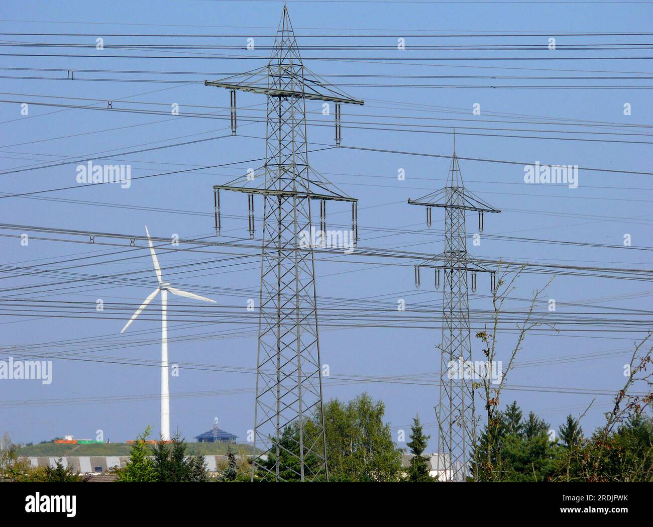 High-voltage pylons and wind turbines for power generation near ...