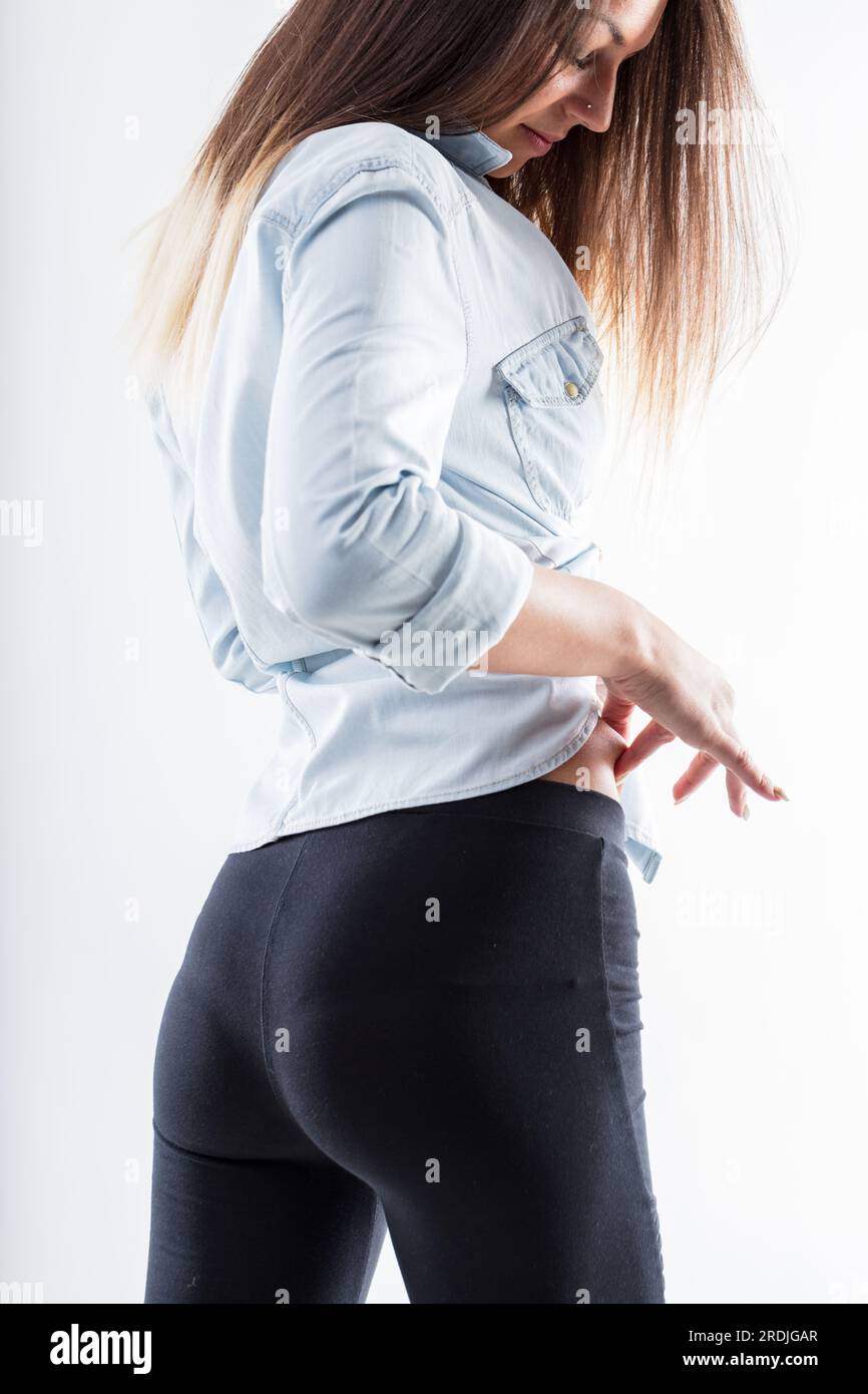 Perfectly toned buttocks of a fitness model, checking her hips and ...
