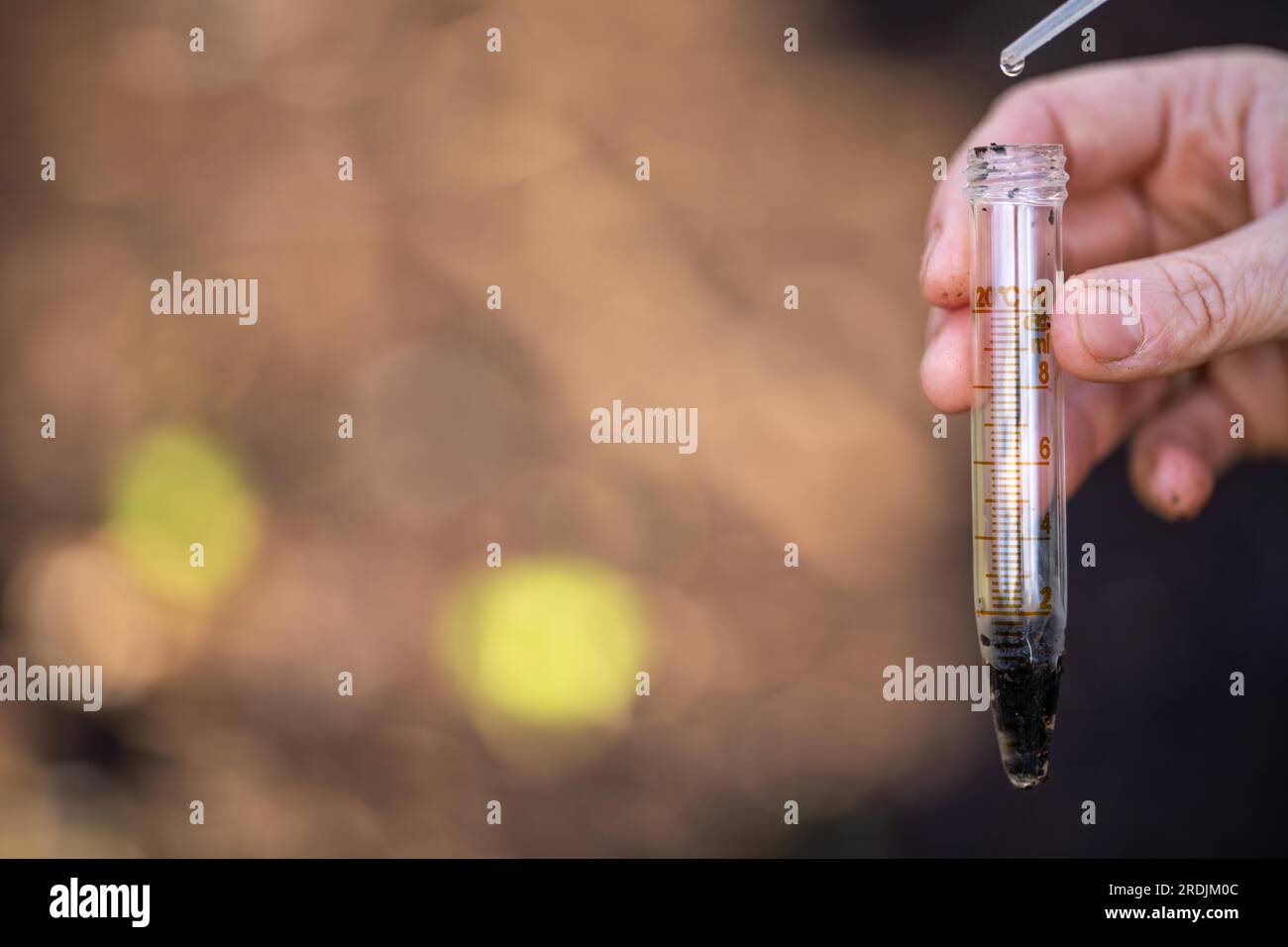 taking a soil sample for a soil test in a field. Testing carbon ...