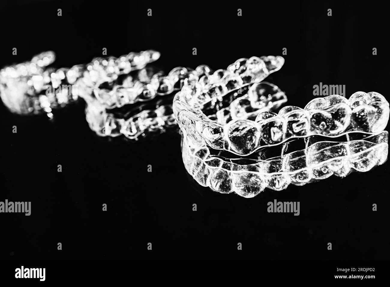 Invisible aligner teeth retainers lie on the mirror in orthodontic ...