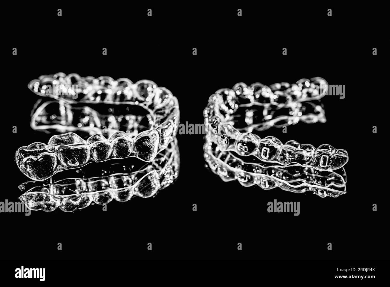 Invisible aligner teeth retainers lie on the mirror in orthodontic ...