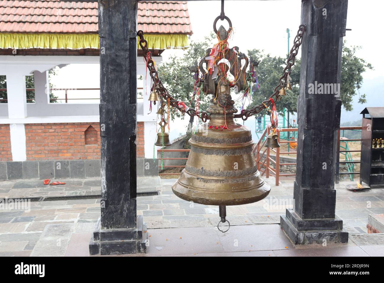 Close up view of a temple bell made up of bronze material, hanged in ...