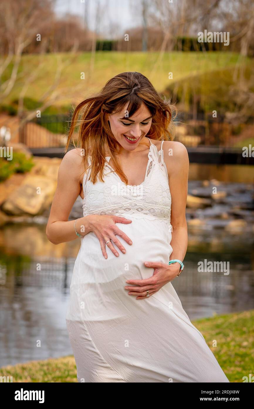A beautiful expectant mother poses in an outdoor environment Stock ...
