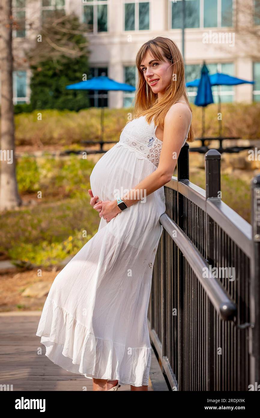 A beautiful expectant mother poses in an outdoor environment Stock ...