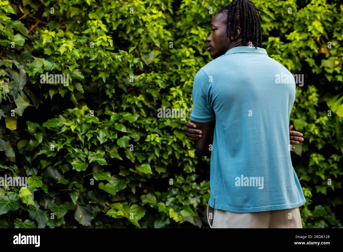 Rear view of african american man with dreadlocks wearing pale blue ...