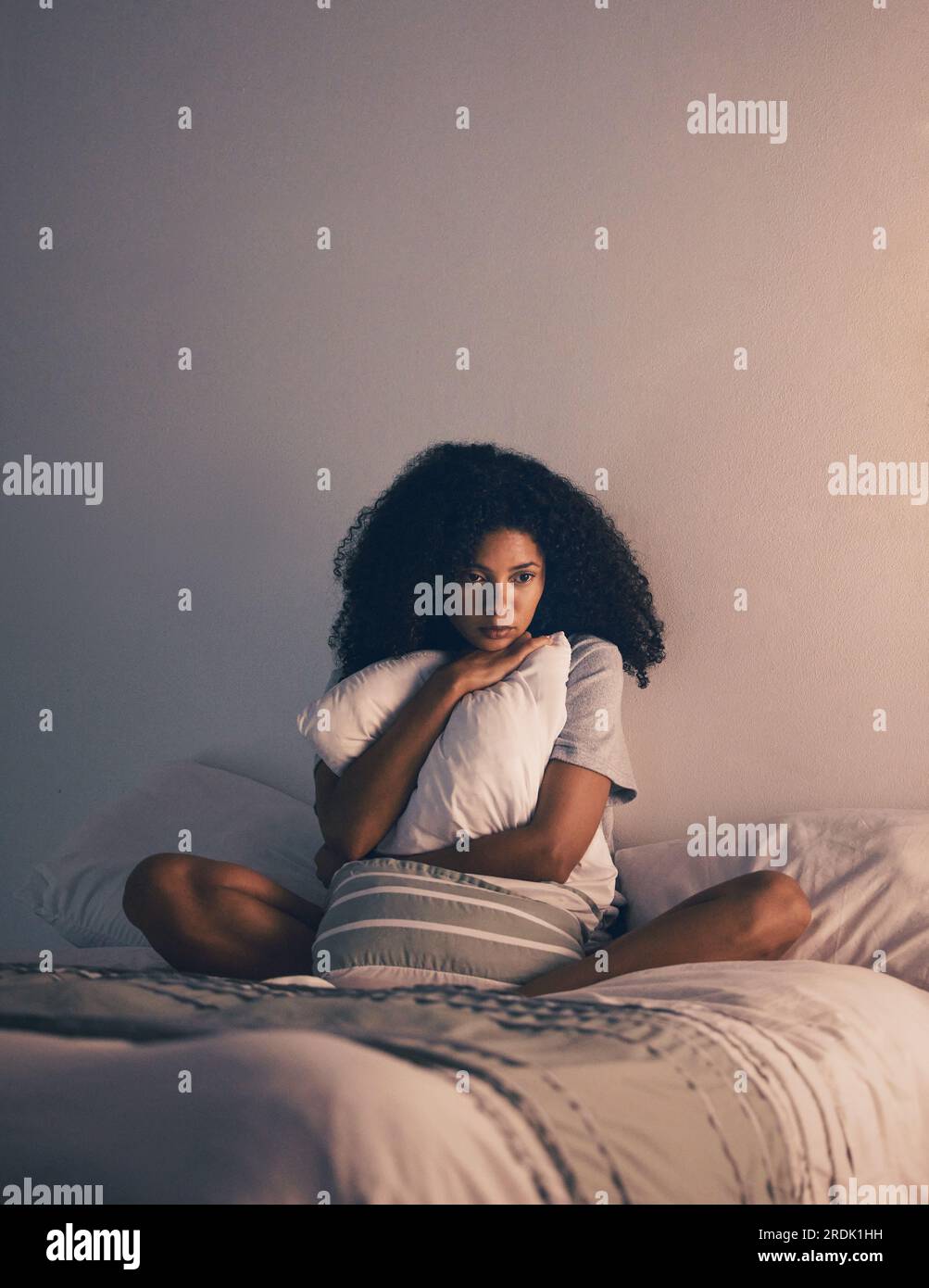 Sad, woman and thinking with depression and pillow hug at home with ...