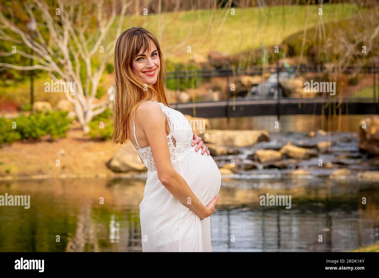 A beautiful expectant mother poses in an outdoor environment Stock ...