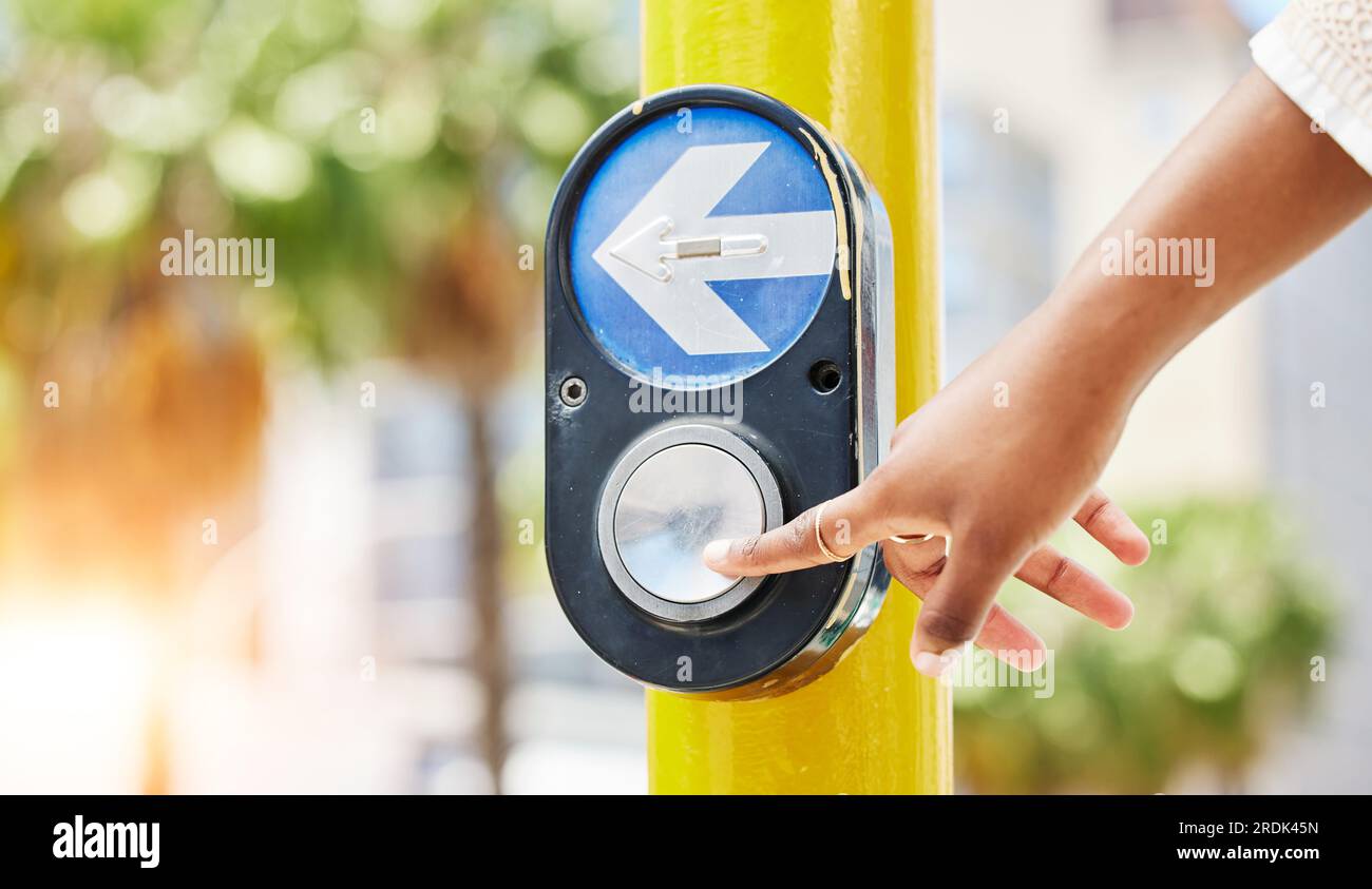 Crosswalk, arrow and button with hand of woman in city for traffic ...