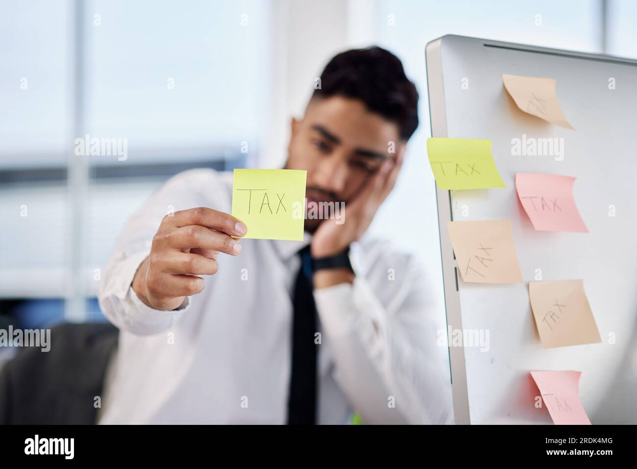 Tax, hand and business man with sticky note in office for debt, audit ...