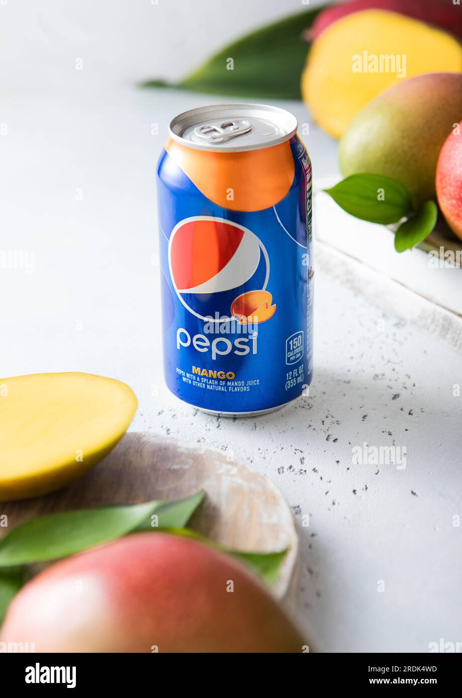 LONDON,UK - MAY 01, 2023: Pepsi soft drink with mango with fresh raw ...
