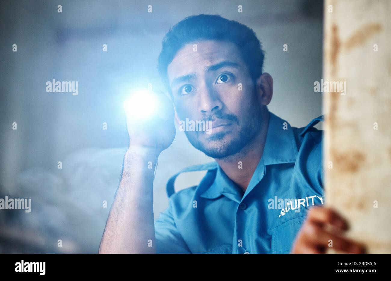 Flashlight, security guard and man in dark room for investigation ...