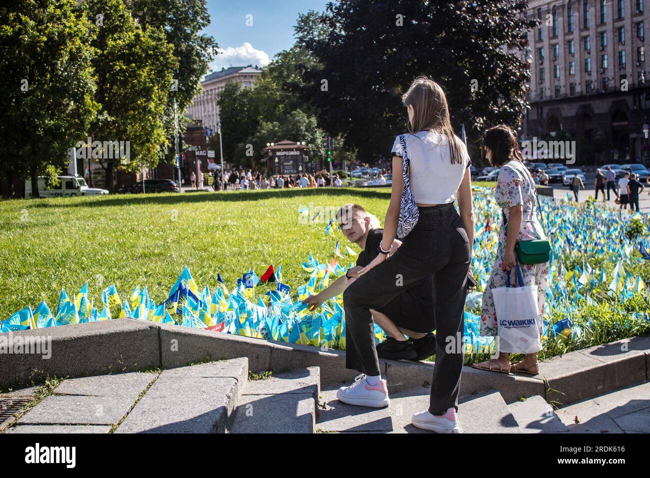 Relatives come planted a flag at the makeshift memorial for fallen ...