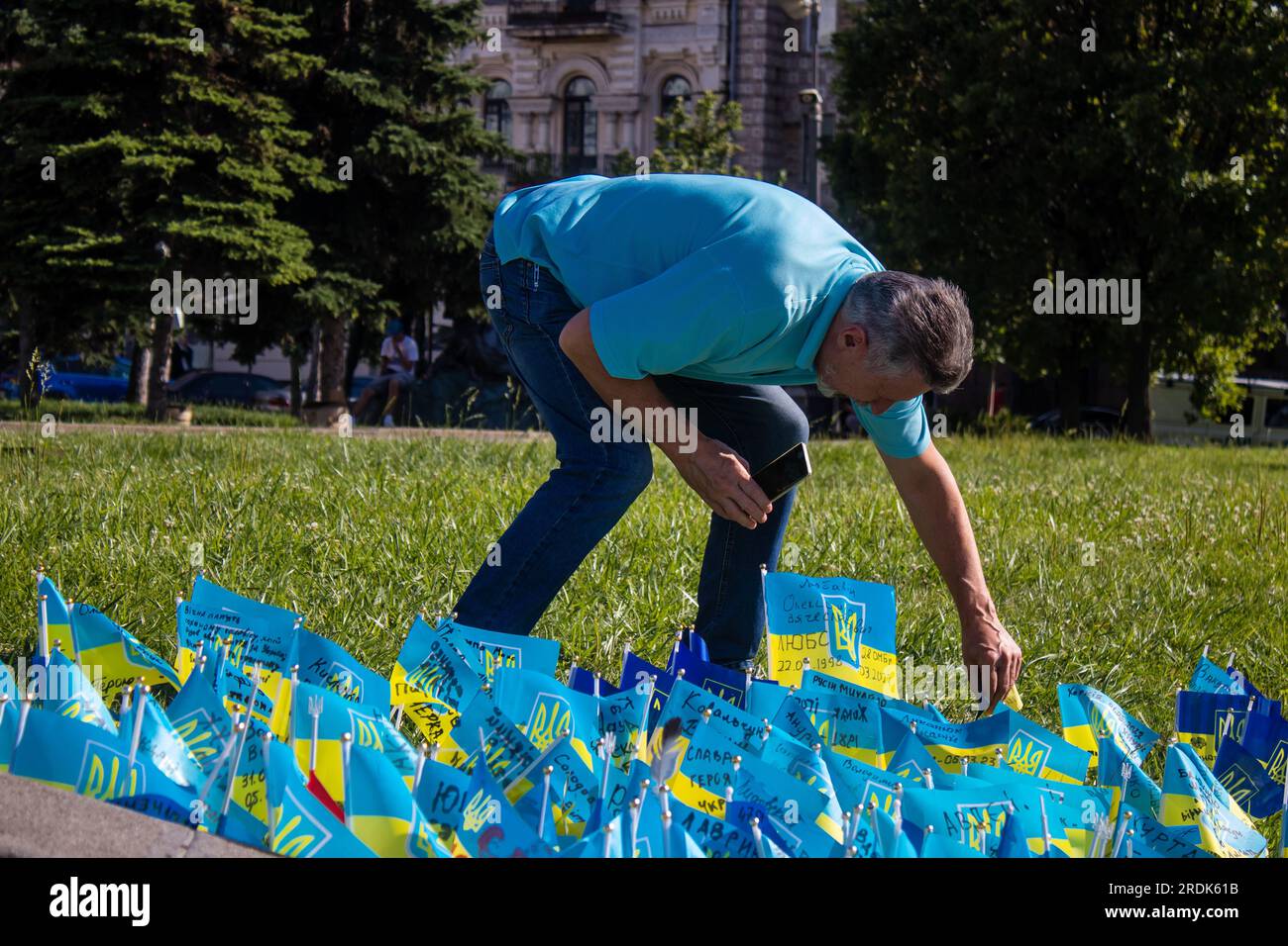 Relatives come planted a flag at the makeshift memorial for fallen ...