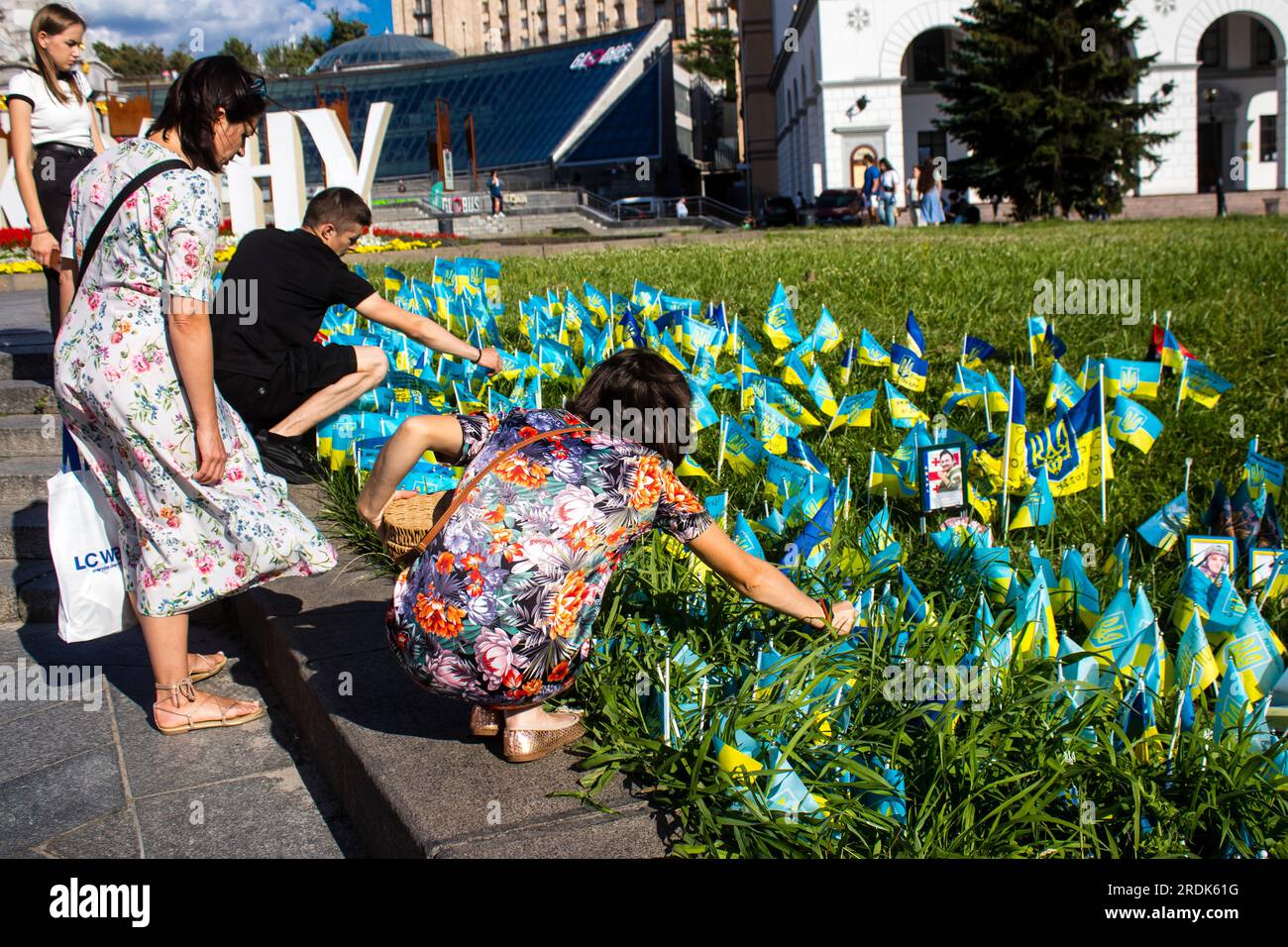 Relatives come planted a flag at the makeshift memorial for fallen ...
