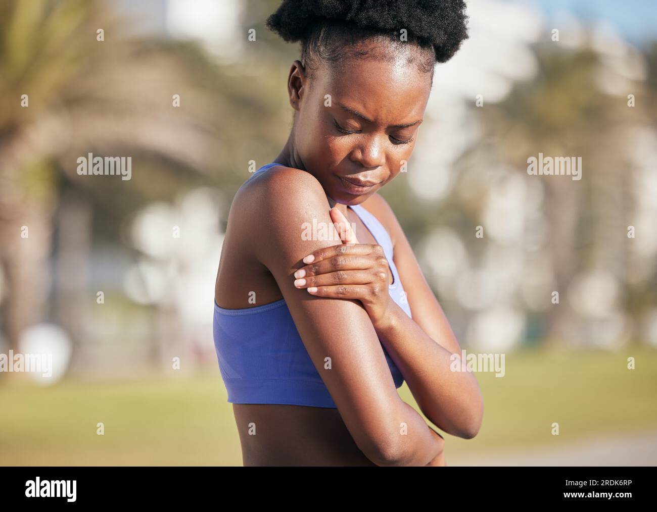 Arm, pain and black woman in outdoor with injury from sport with strain ...