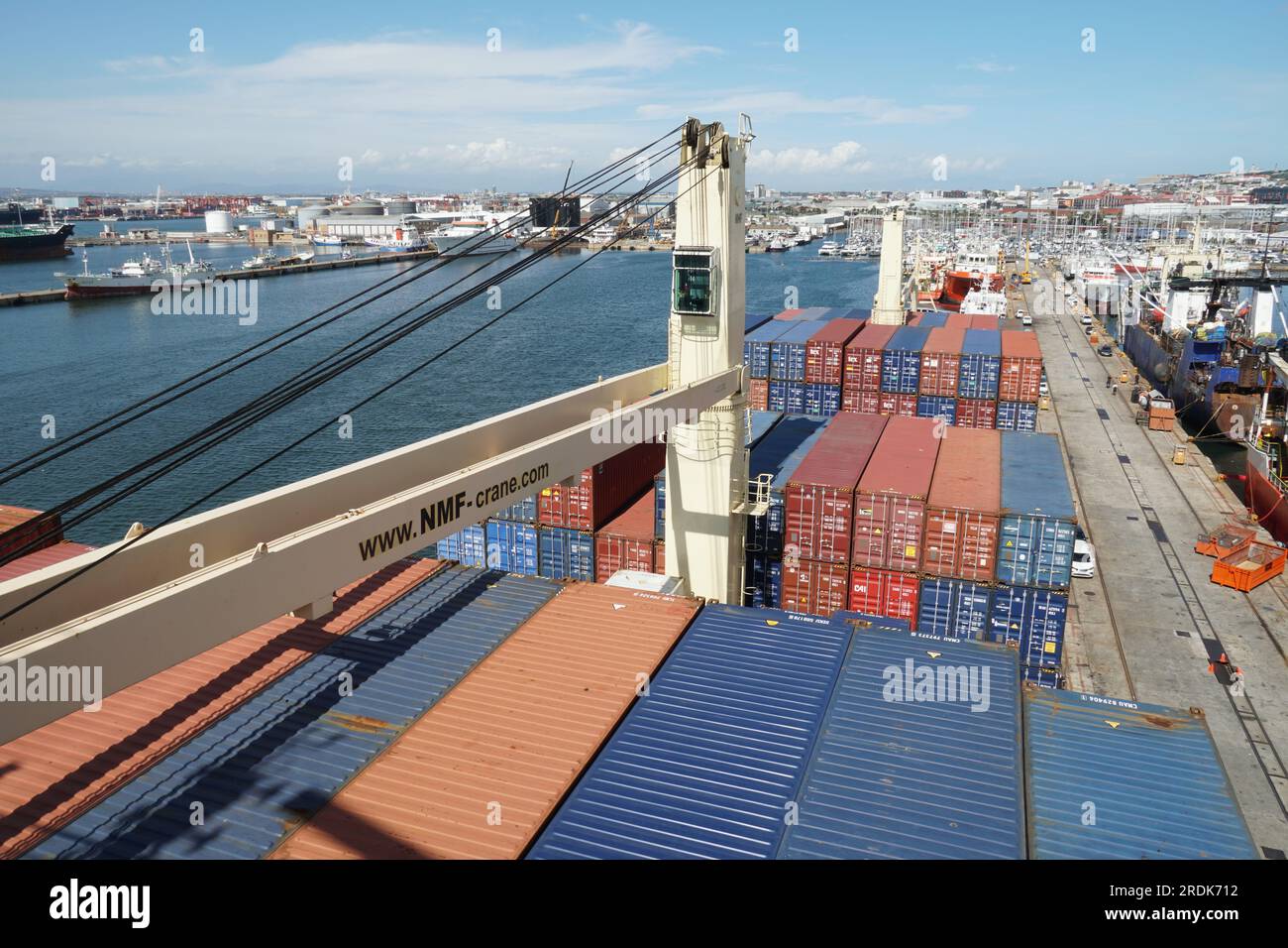 Container vessel with cranes is fully loaded and moored in port of Cape ...