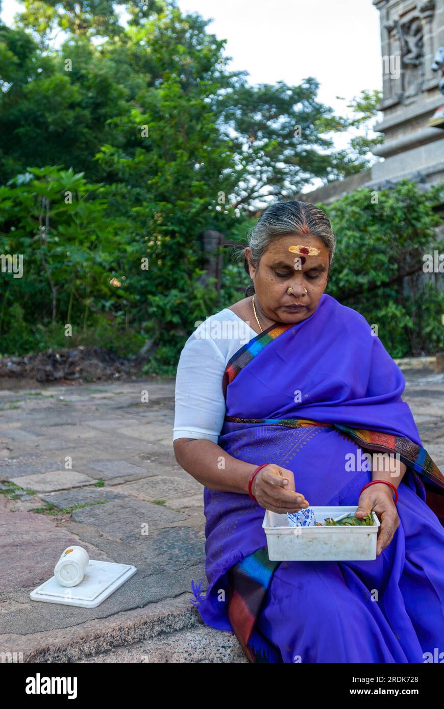 A devotee enjoying betel leaf in Thillai Nataraja temple, Chidambaram ...
