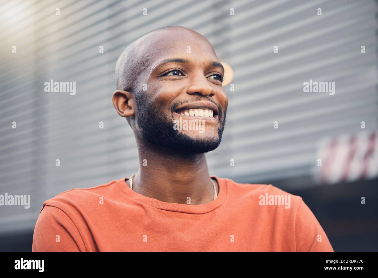 Black man, smile and thinking outdoor on a city street with a positive ...