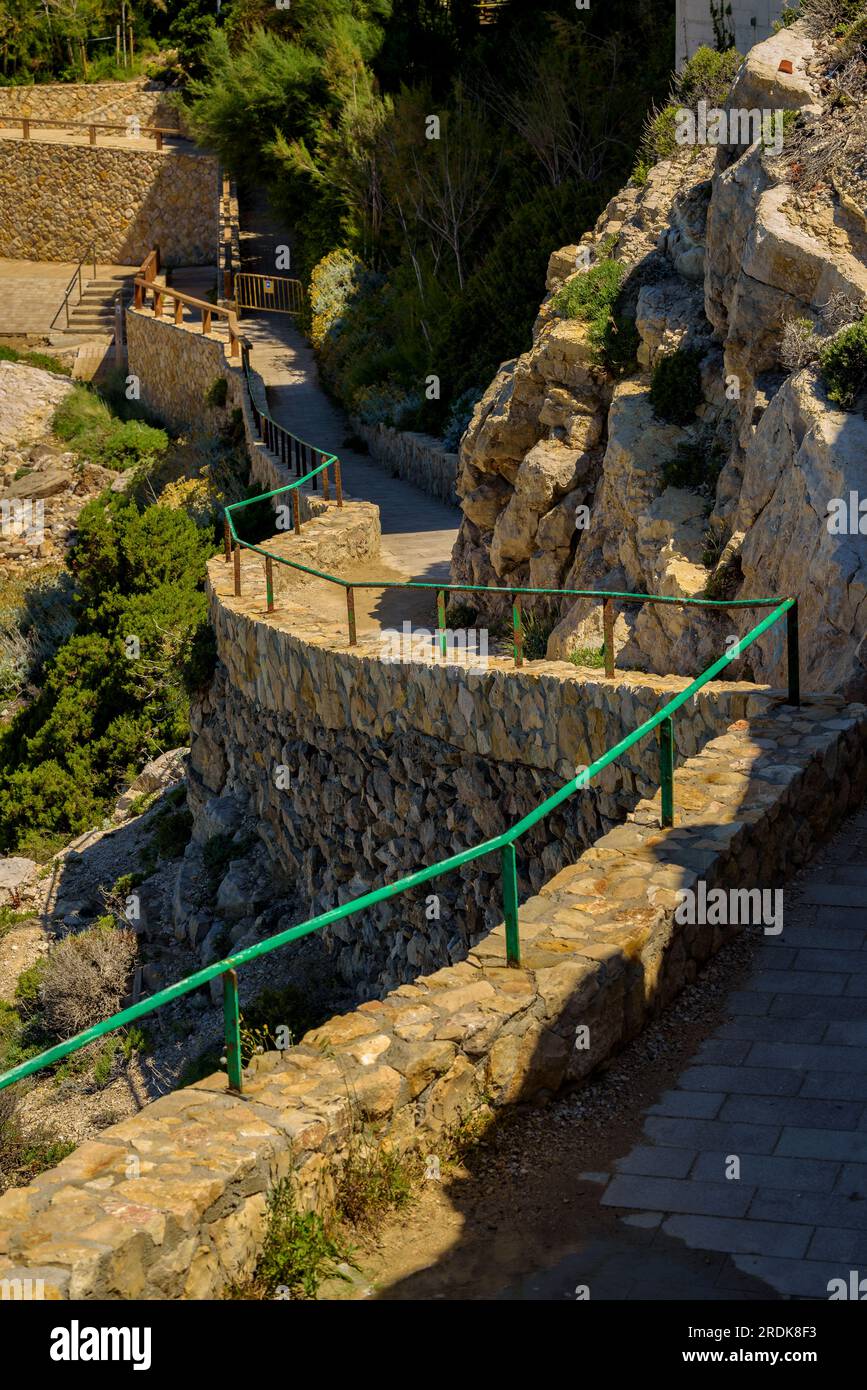 Coastal path overlooking the sea as it passes through Salou beaches, on ...