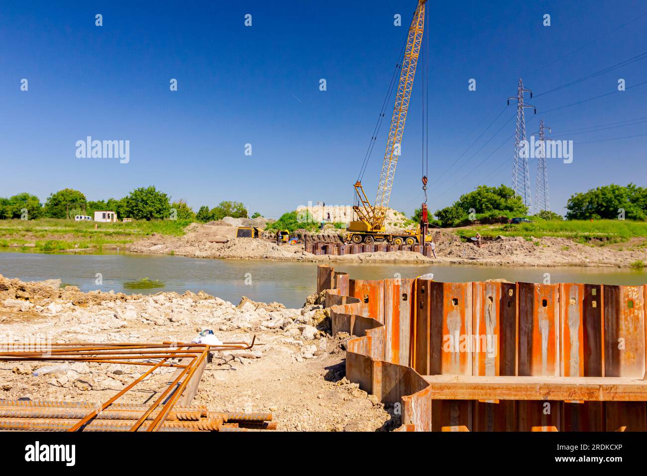 Installed rusty metal piles along river bank built in for bridge ...