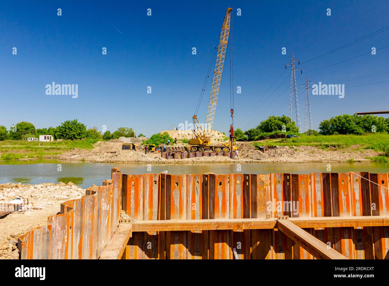 Installed rusty metal piles along river bank built in for bridge ...