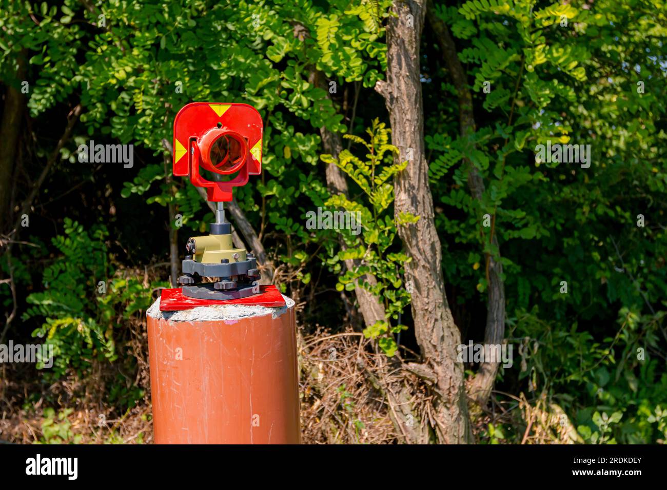 Part of leveler device on red metal pole ensures precise measurements ...