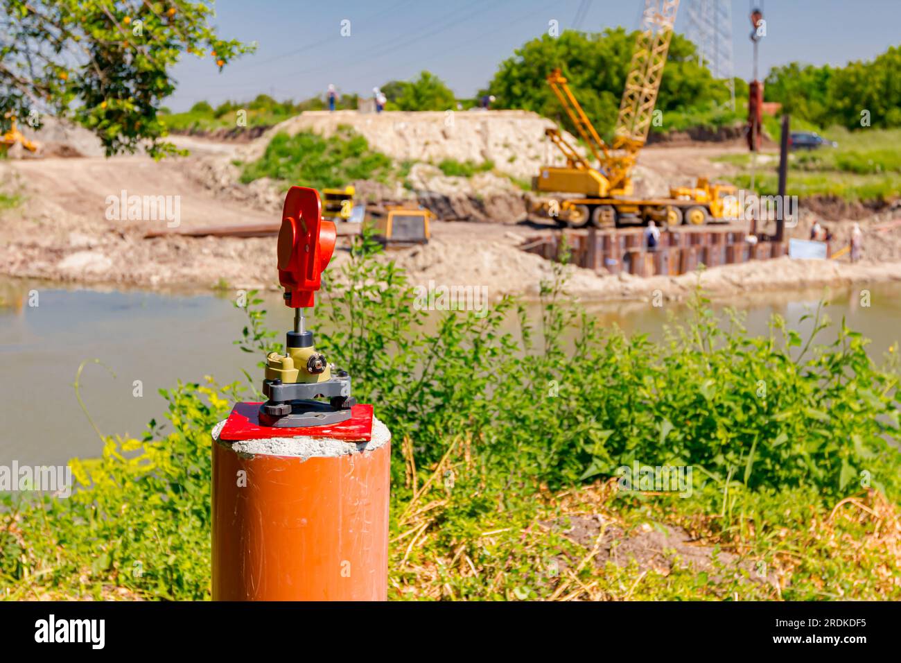 Part of leveler device on red metal pole ensures precise measurements ...