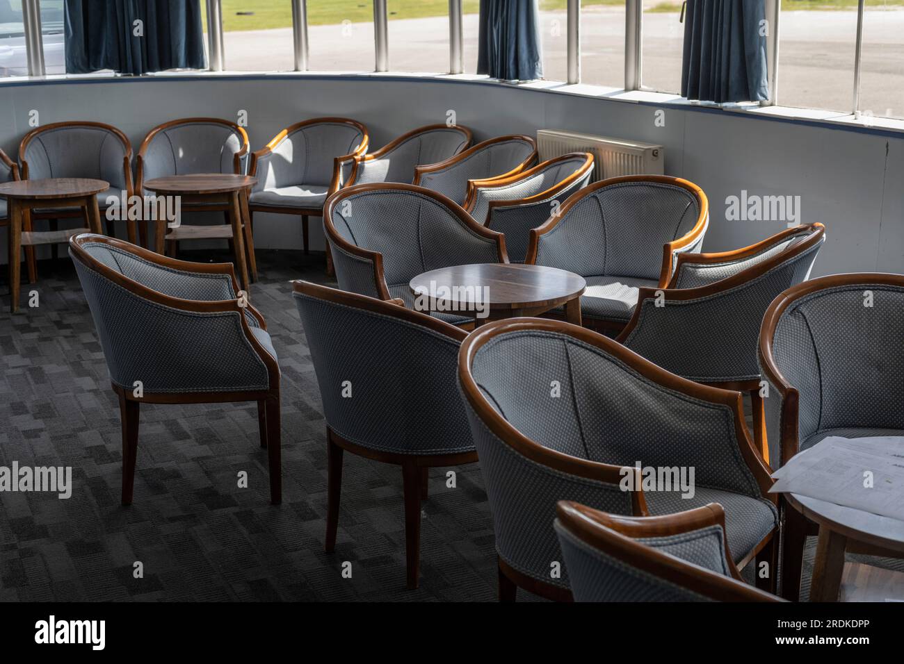 An empty social room in a small airport with club chairs in the South ...