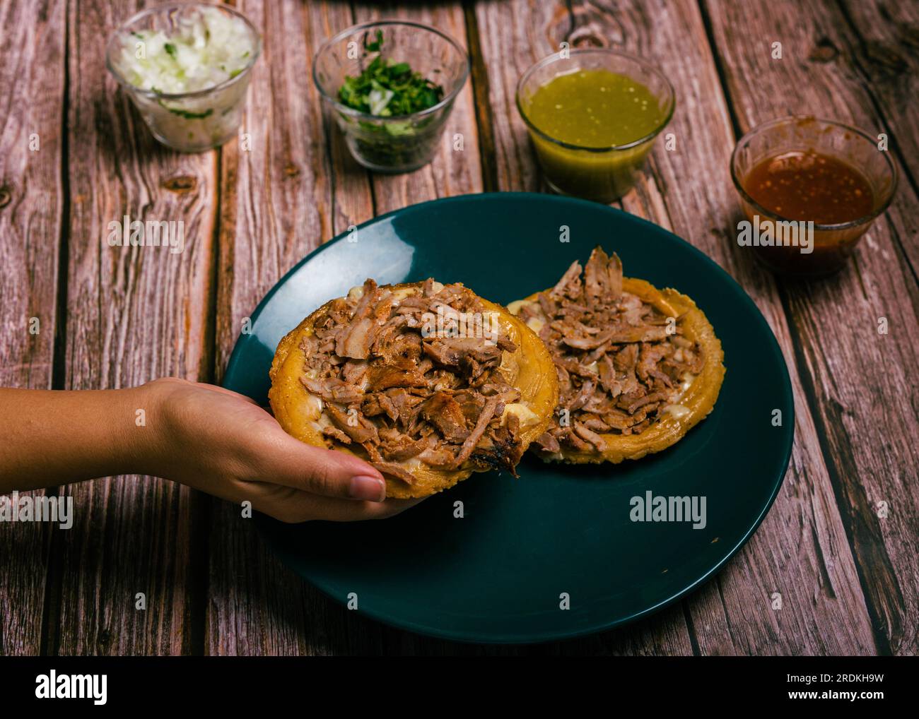 Sope pocho, typical Mexican food served with condiments on a wooden ...